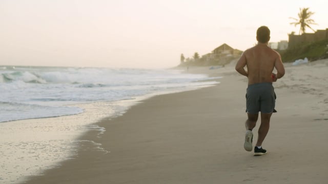 Man jogging on the beach - Free Stock Video Footage | Coverr