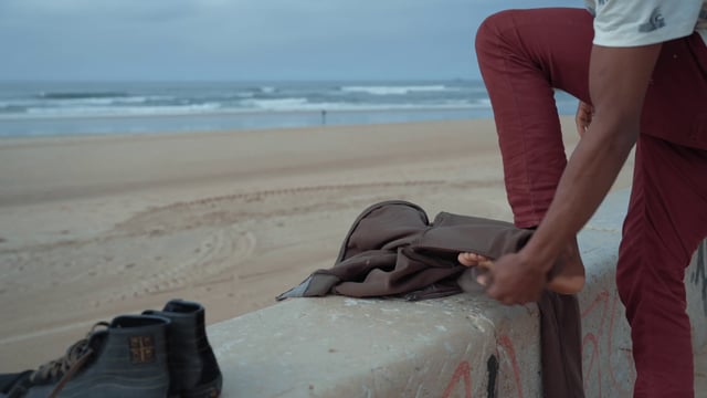 A man cleaning sand from his feet - Free Stock Video Footage | Coverr