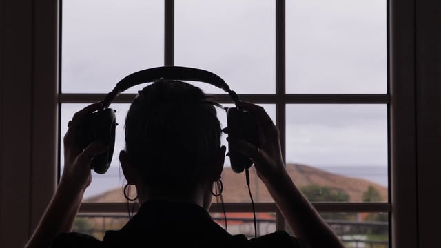 Woman putting on headphones - Free Stock Video Footage | Coverr