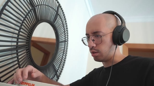 A guy listening to music while flipping through vinyl records - Free ...