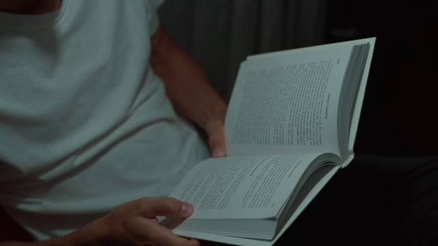A man reading a book at home late at night - Free Stock Video Footage ...