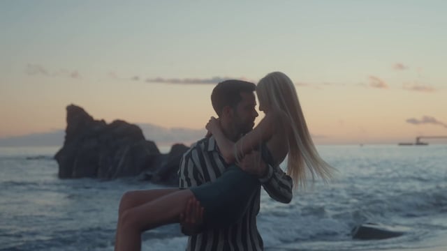 A man picking up a woman with his arms at the beach - Free Stock Video ...